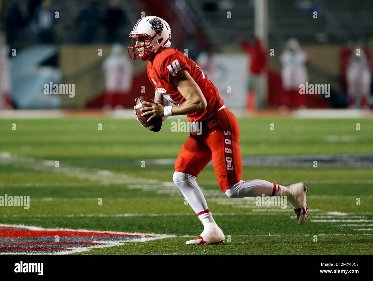 New Mexico quarterback Austin Apodaca picks up extra yardage during the ...