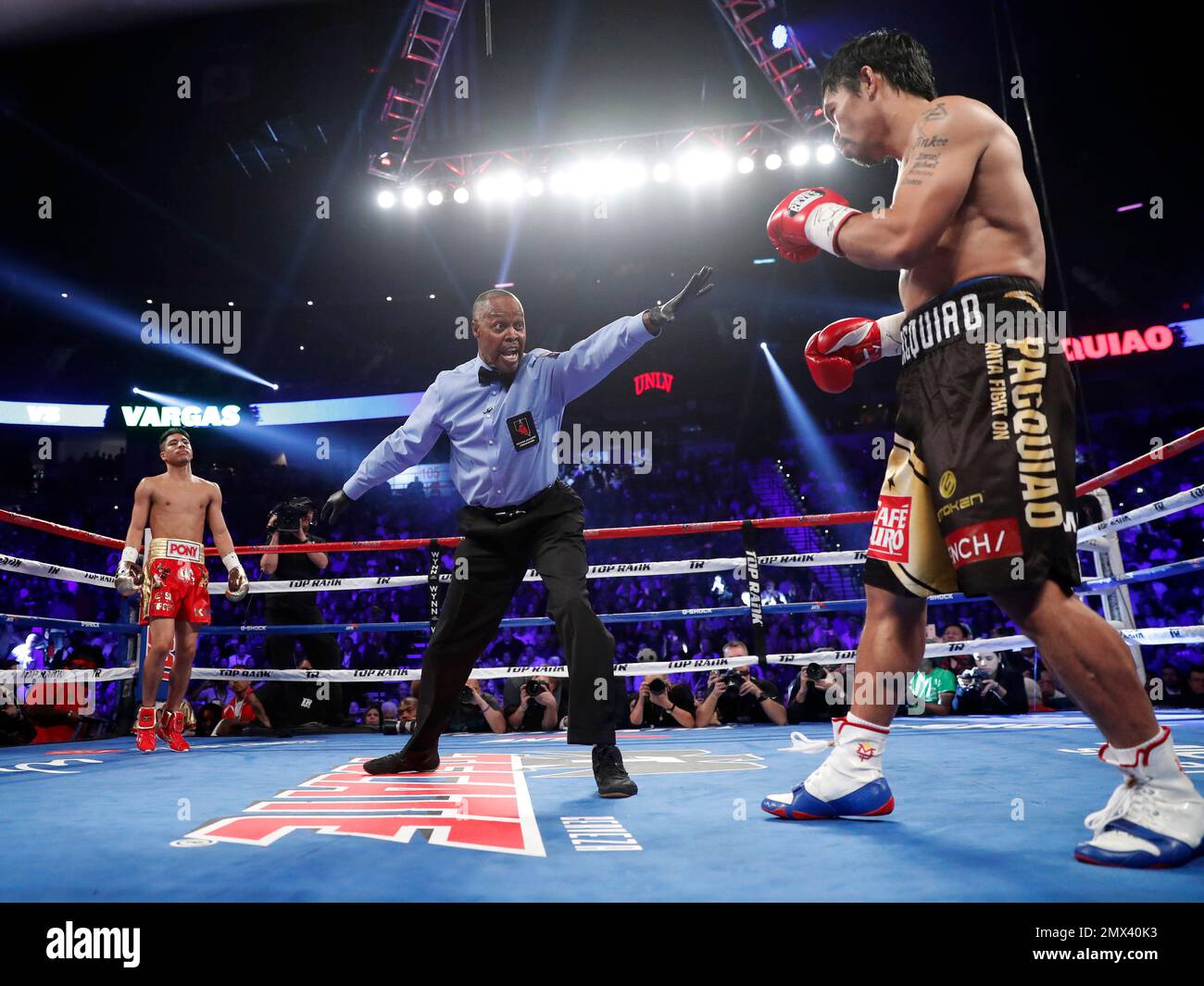 Referee Kenny Bayless starts the fight between Jessie Vargas, left, and ...