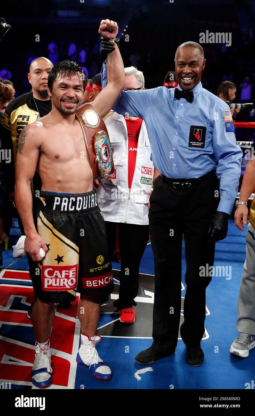 Referee Kenny Bayless, right, holds up the hand of Manny Pacquiao, of ...