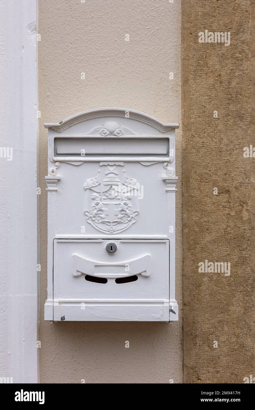 Close up view of a white vintage letterbox, on the exterior of building ...