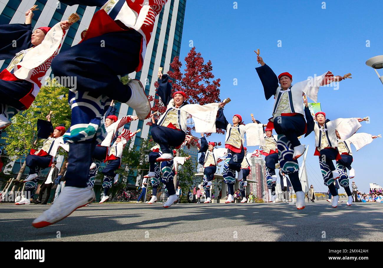 Participants perform as they parade through Tokyo streets during an ...