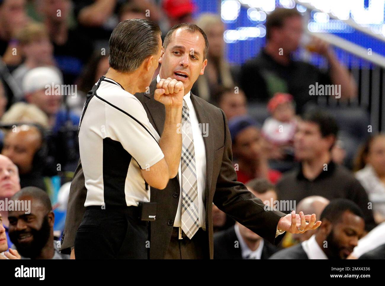 Orlando Magic head coach Frank Vogel talks to a referee Ken Mauer, left ...