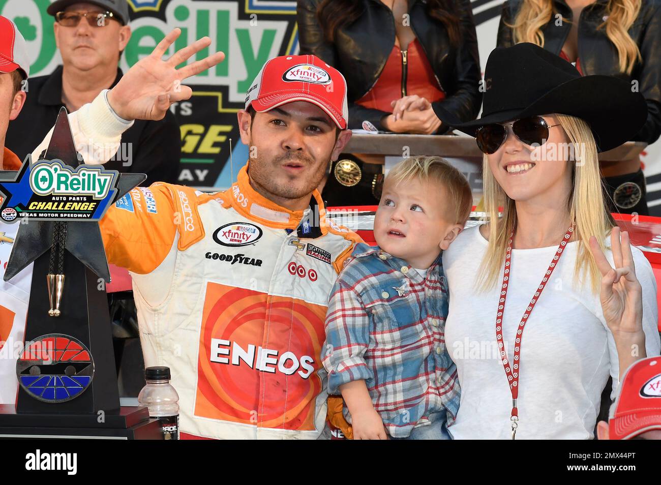 Kyle Larson, left, posse for photos with his son Owen, center, and ...