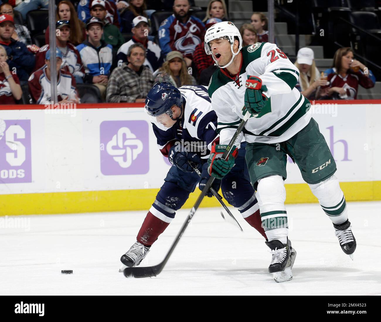 Colorado Avalanche center John Mitchell (7) hits Minnesota Wild right ... Colorado Avalanche center John Mitchell (7) hits Minnesota Wild right ...