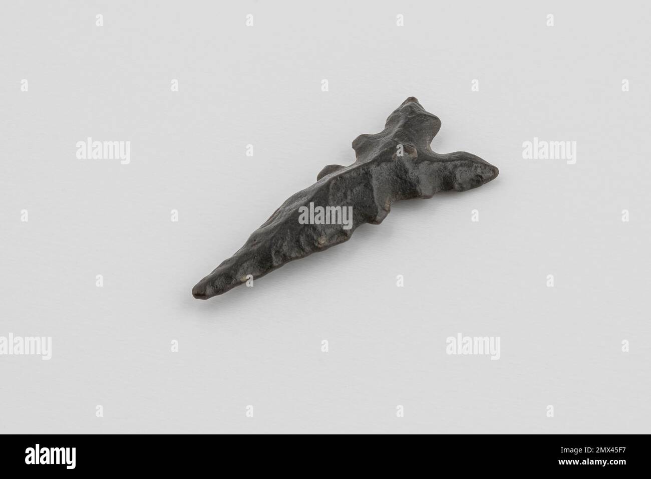 Macro image of an original arrowhead from the Paleolithic Age. High ...