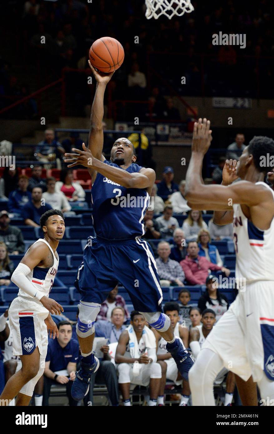 Southern Connecticut's Michael Mallory between Connecticut's Jalen ...