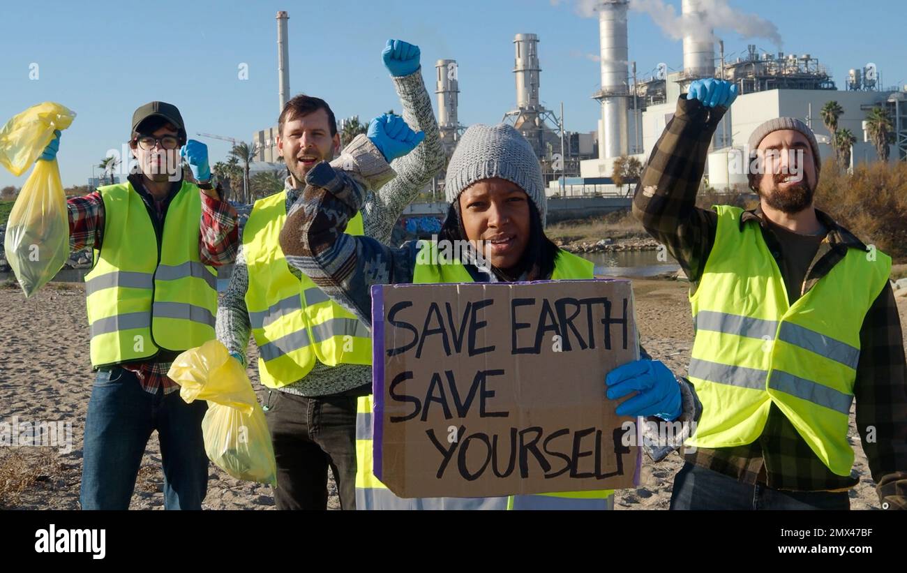 Group of young multiethnic volunteers collecting garbage in nature ...