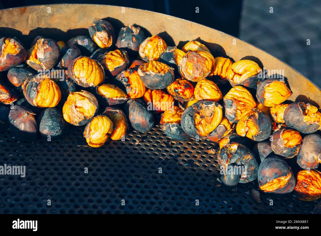 Roasted chestnuts on the tray . Chinese street food Stock Photo - Alamy