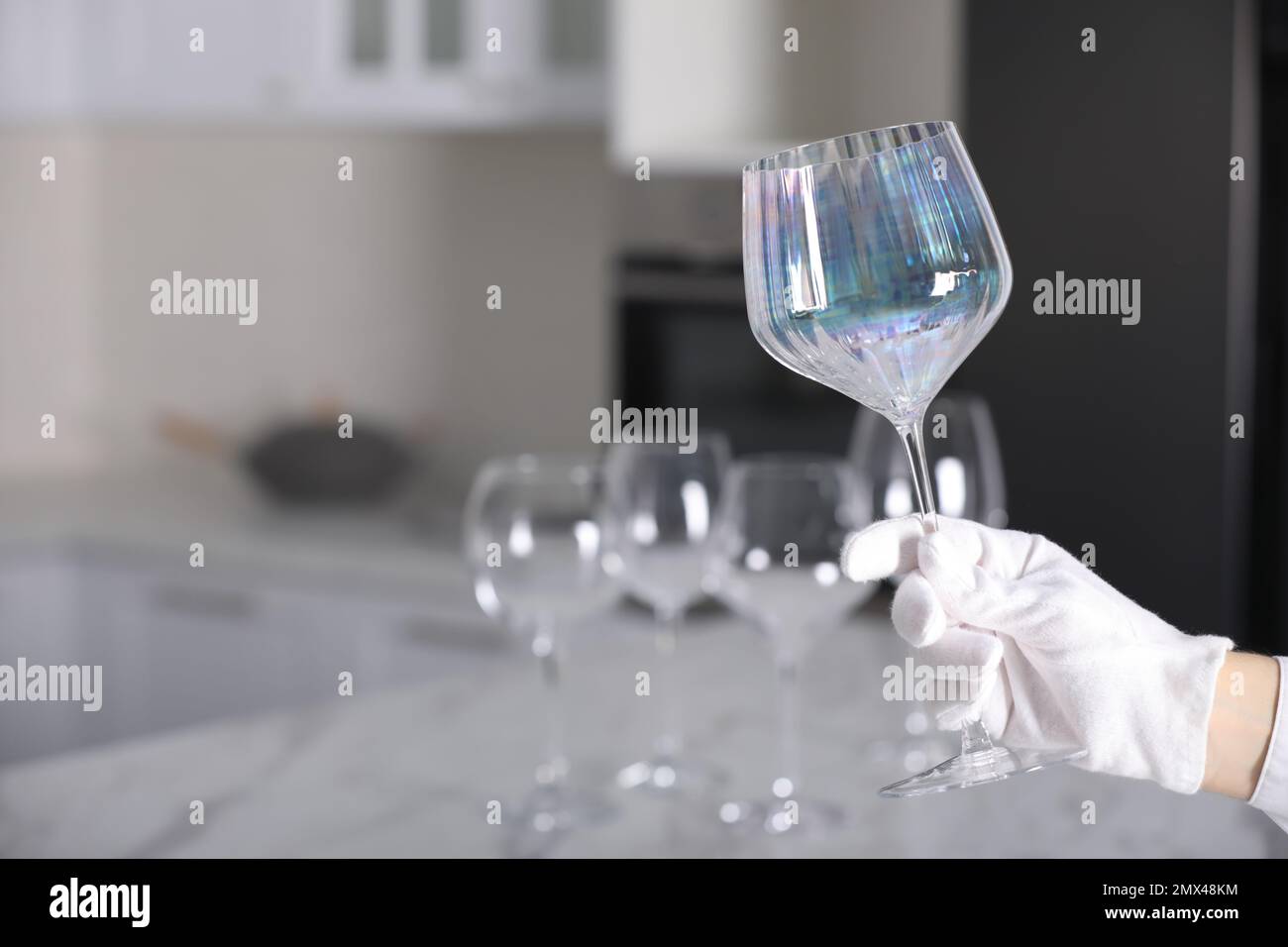 Person in white glove checking cleanliness of glass indoors, closeup ...
