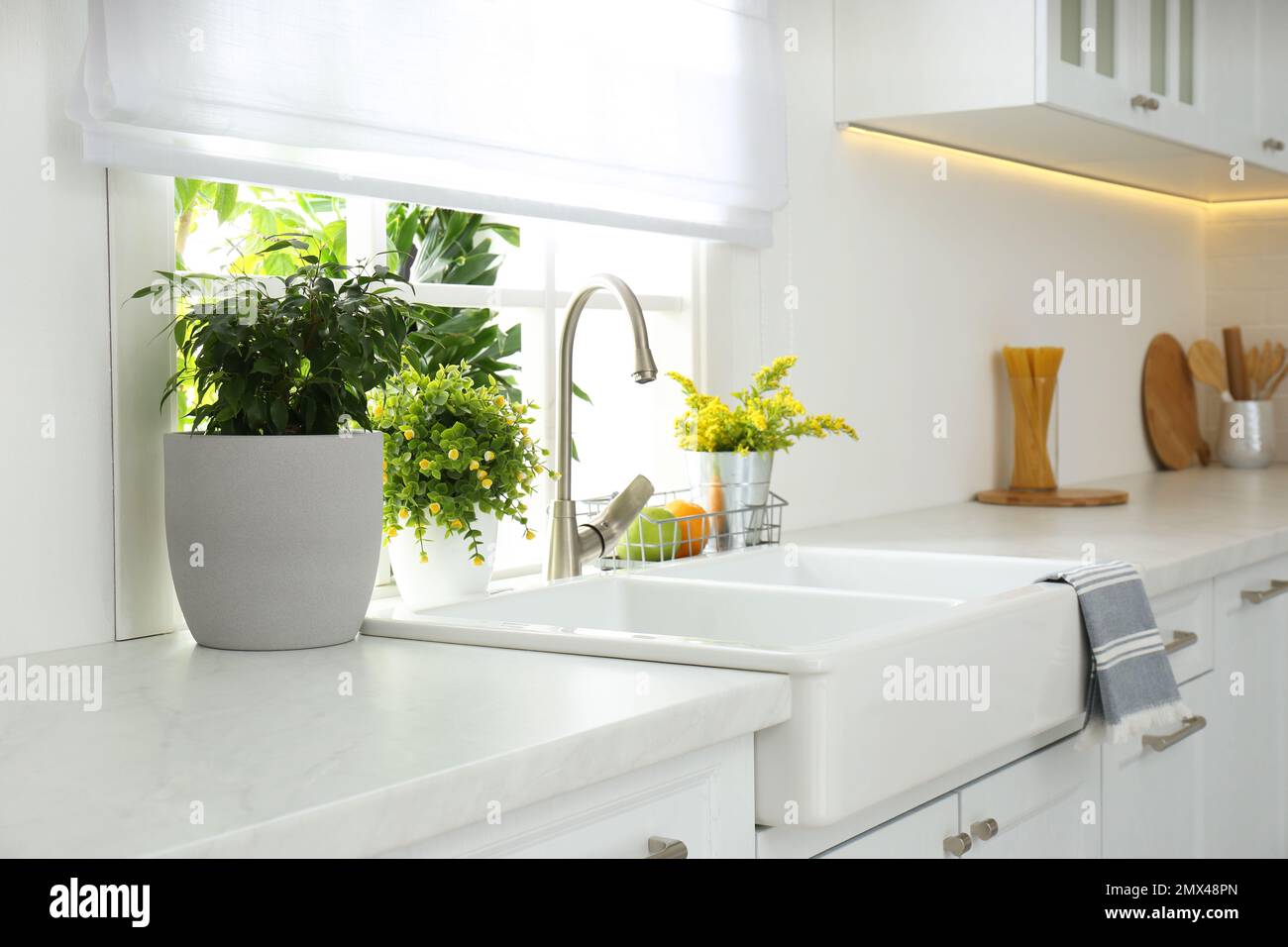 Beautiful white sink near window in modern kitchen Stock Photo - Alamy