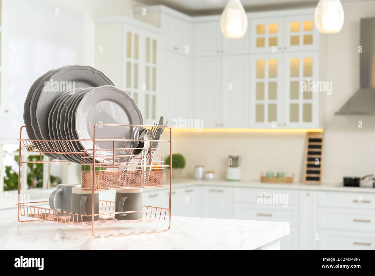 Drying rack with clean dishes on table in kitchen. Space for text Stock ...