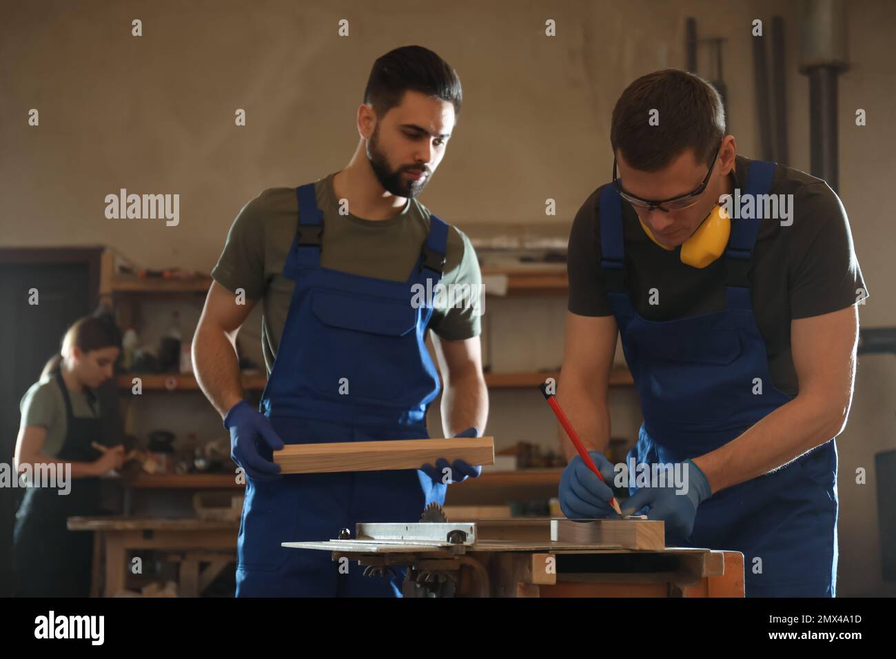 Professional carpenters working with wood in shop Stock Photo - Alamy