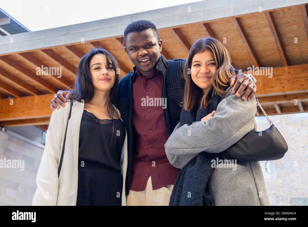 Attractive coworkers portrait outside the office. Group of three ...