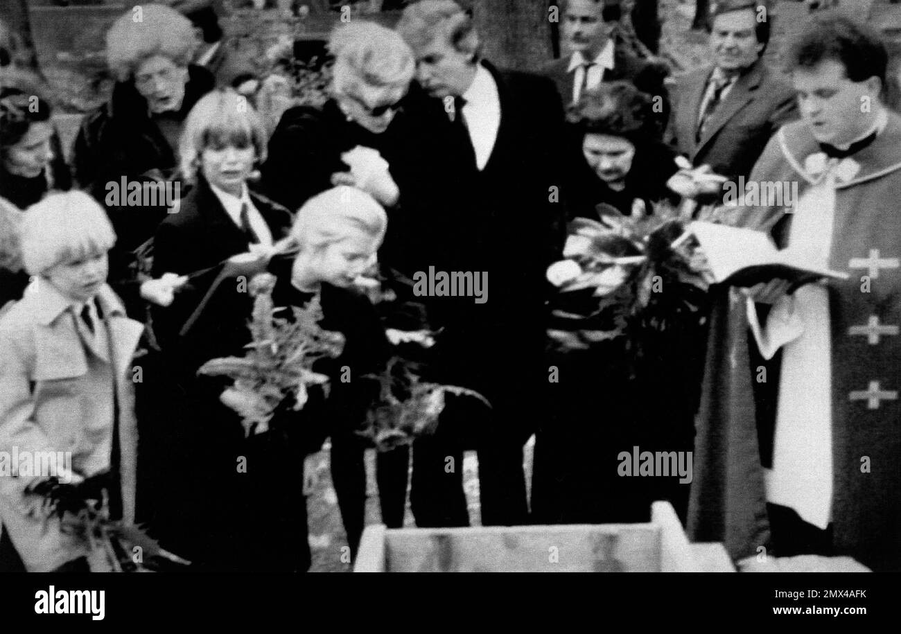 Family gathers around the burial site of Milos Zelnicek, father of ...