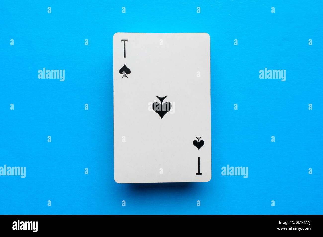 Playing card ace of spades on a blue background Stock Photo - Alamy