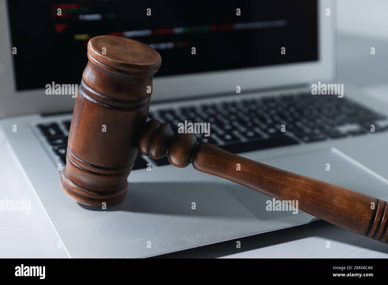 Laptop and wooden gavel on light table. Cyber crime Stock Photo - Alamy