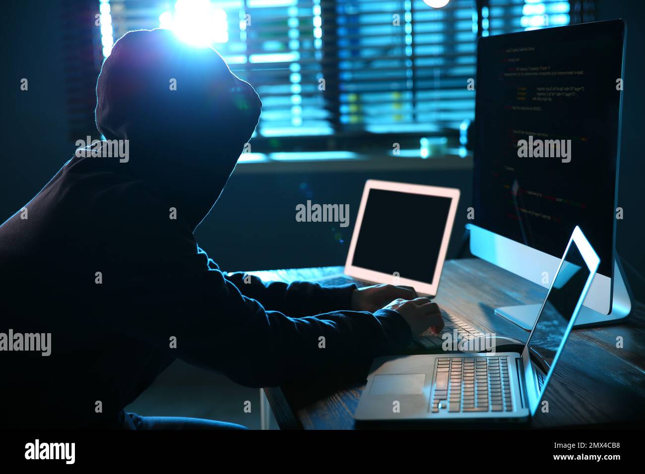 Hacker with computers in dark room. Cyber crime Stock Photo - Alamy