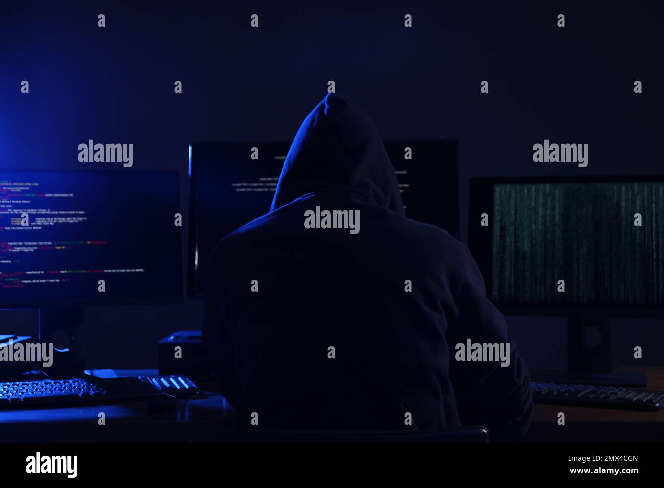 Hacker with computers in dark room. Cyber crime Stock Photo - Alamy