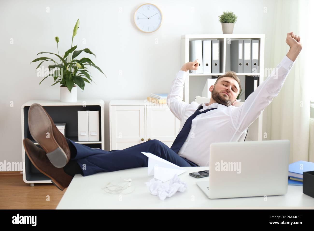 Man stretching in chair hi-res stock photography and images - Alamy