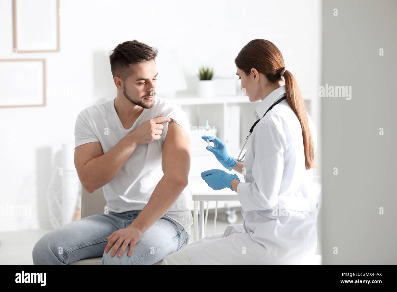 Doctor giving injection to patient in hospital. Vaccination concept ...