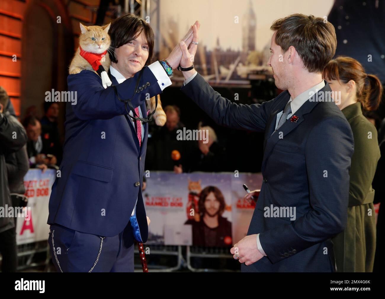 Writer James Bowen, left, greets actor Luke Treadaway, whilst Bob the ...