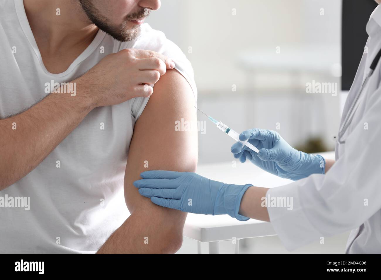 Doctor giving injection to patient in hospital, closeup. Vaccination ...
