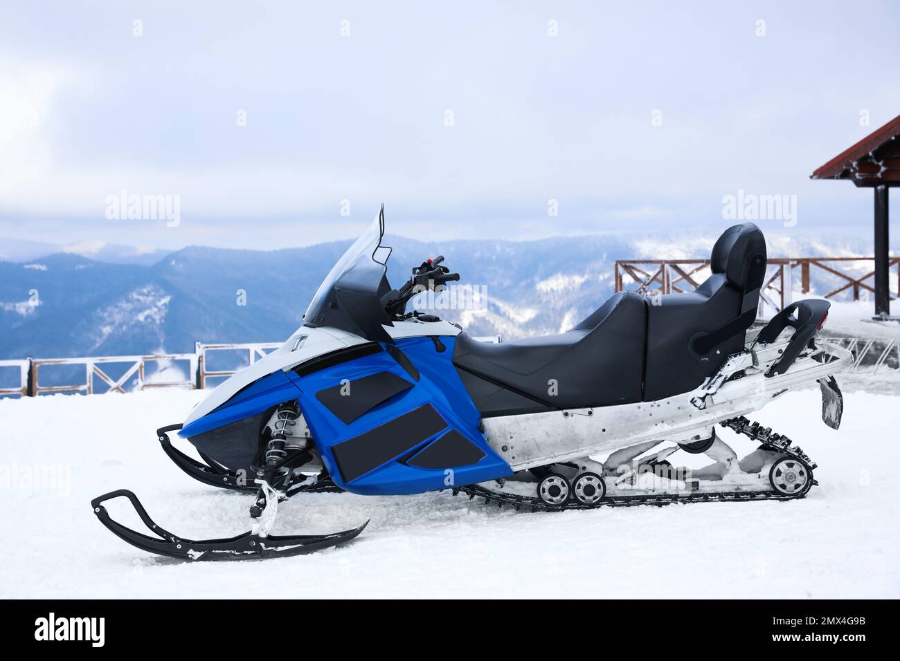 Modern snowmobile on hill at mountain ski resort Stock Photo - Alamy