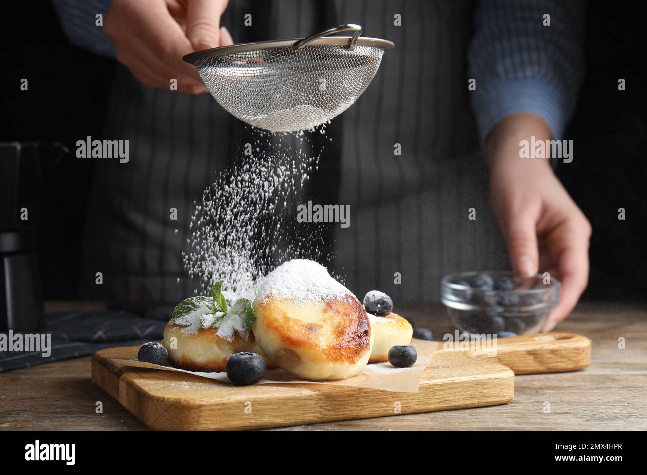 Woman sieving sugar on hi-res stock photography and images - Alamy