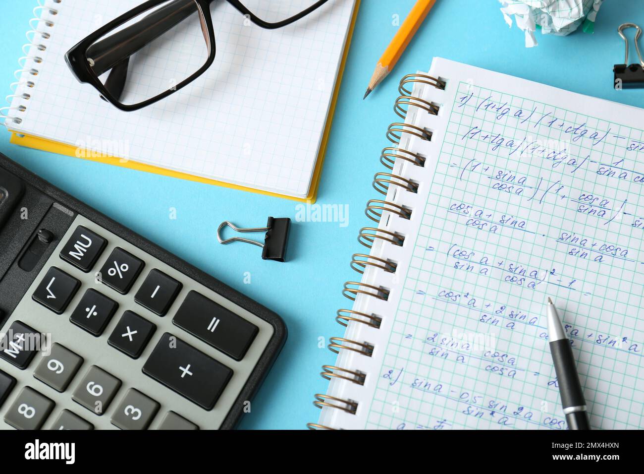 Flat lay composition with notebook and stationery on turquoise table ...