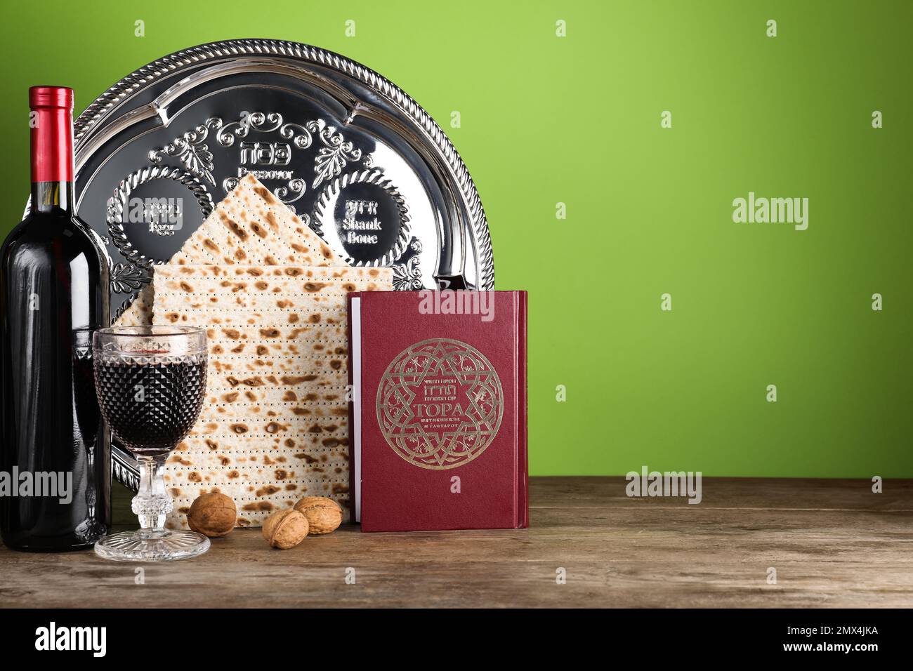 Symbolic Pesach (Passover Seder) items on wooden table, space for text ...