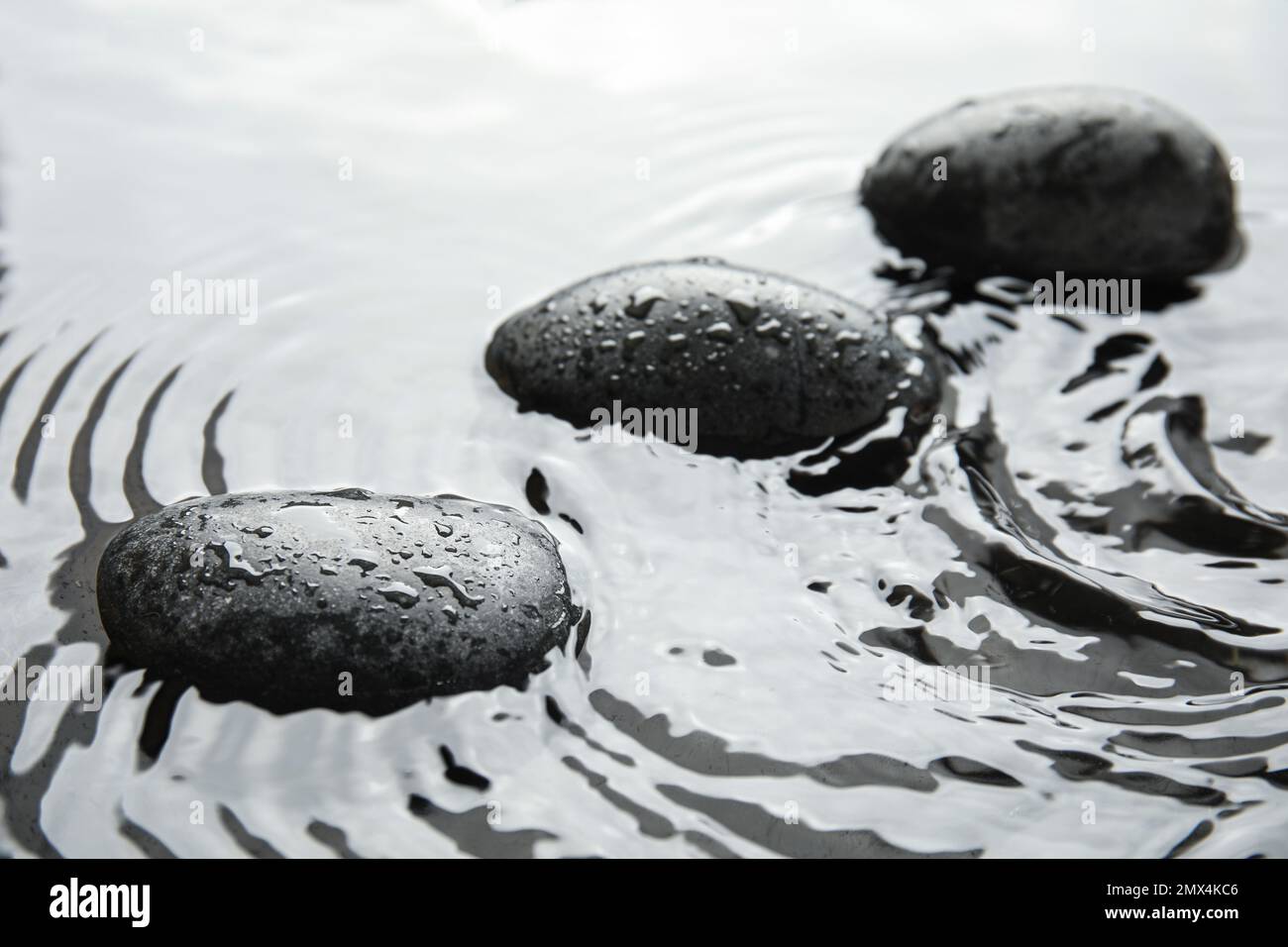 Spa stones in water, closeup. Zen lifestyle Stock Photo - Alamy