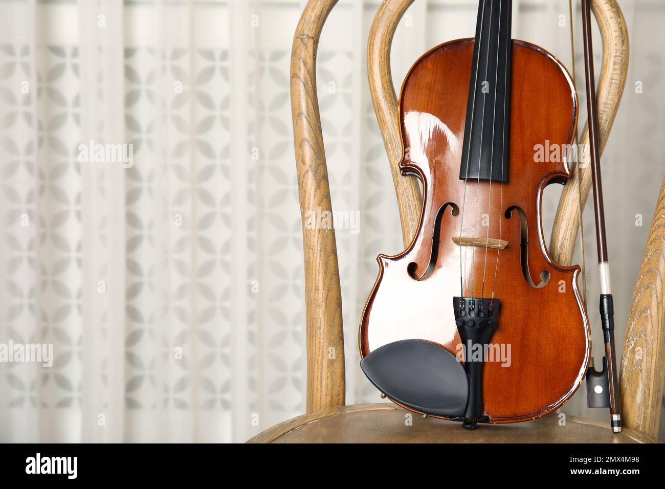 Classic violin and bow on chair indoors. Space for text Stock Photo - Alamy