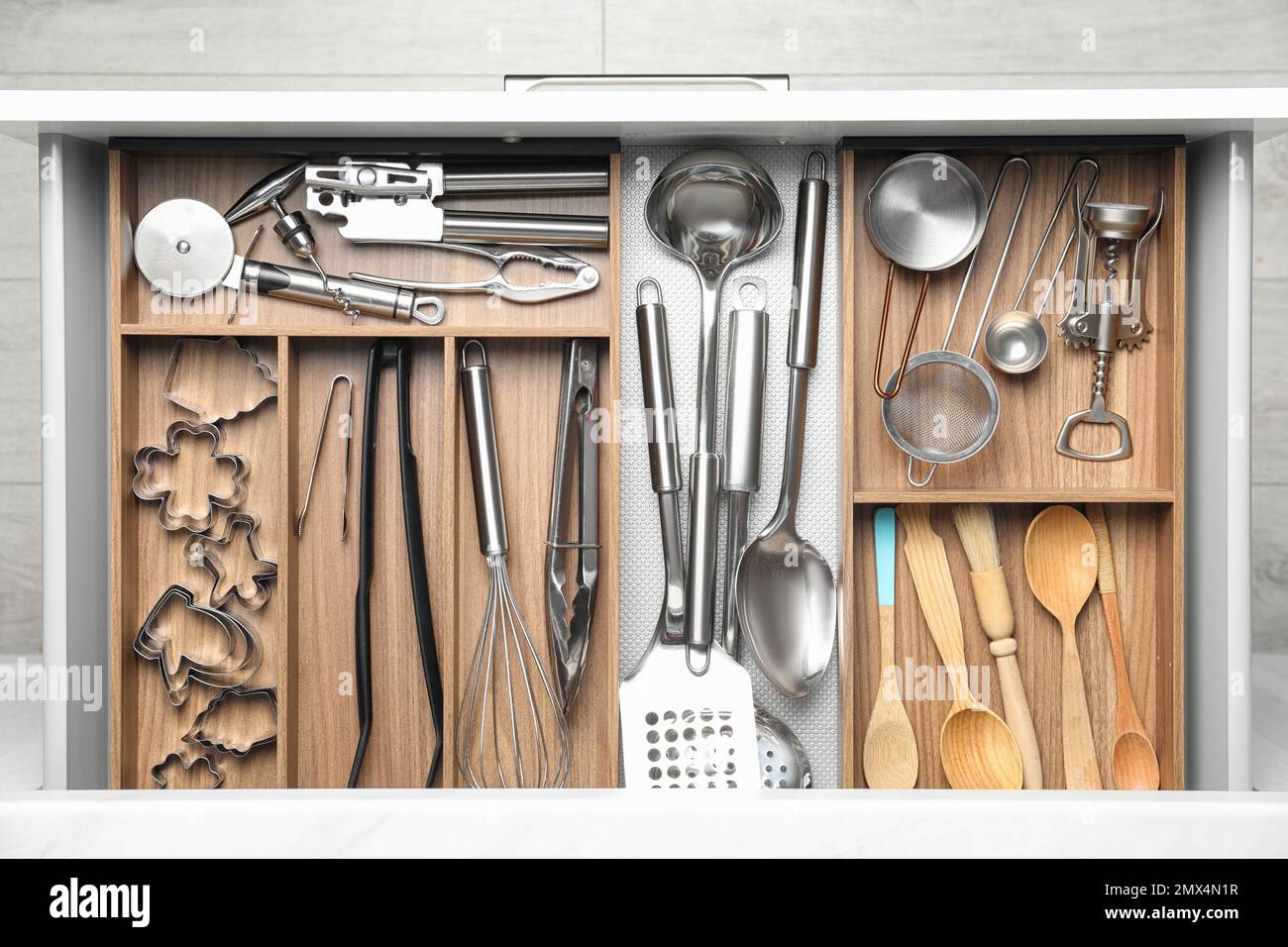 Different utensils in open desk drawer, top view Stock Photo - Alamy