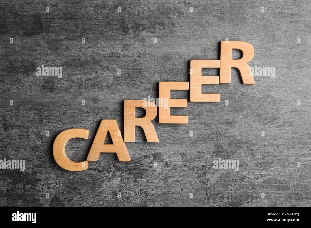 Word CAREER made with wooden letters on grey stone background, flat lay ...