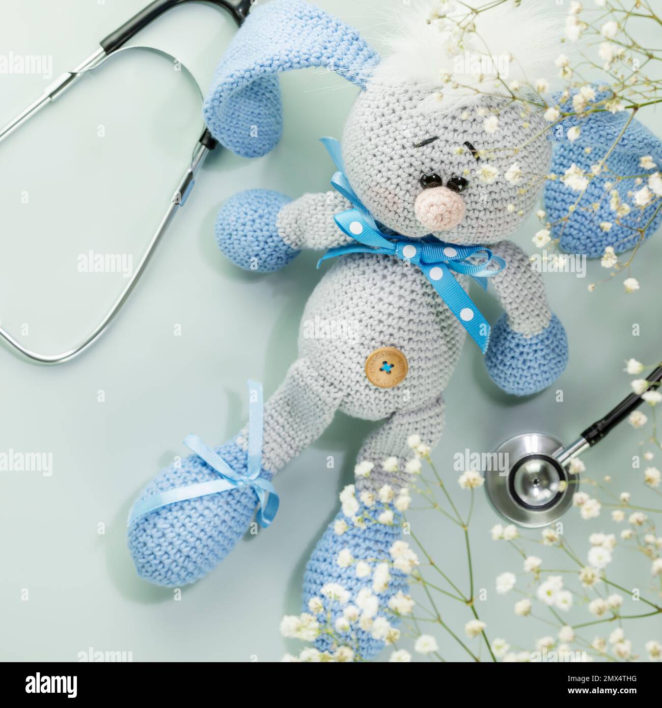 Kids health care still life. Cute knitted toy rabbit with a stethoscope ...