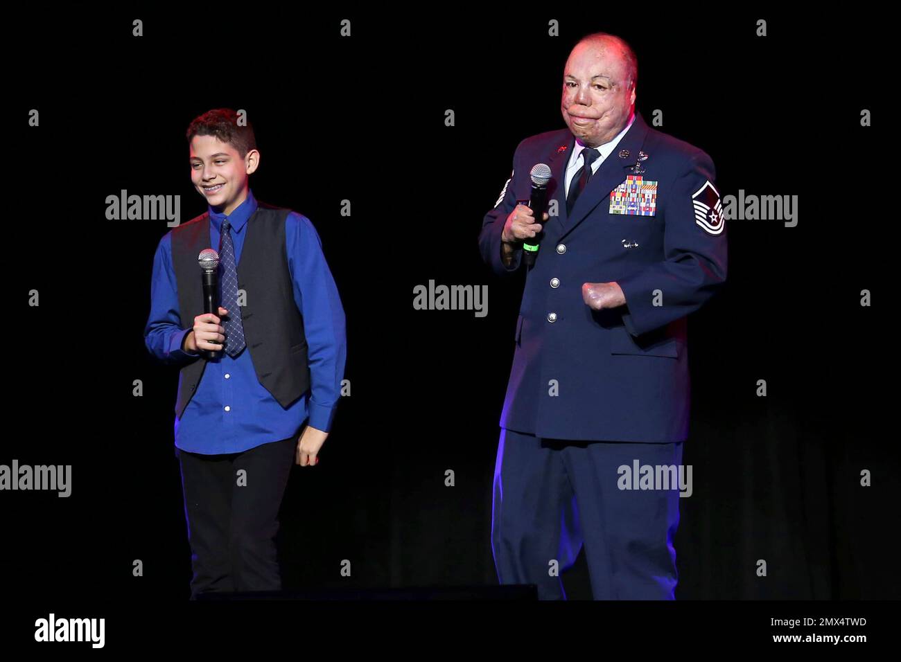 Israel Del Toro, right, and his son appear on stage at Stand Up For ...