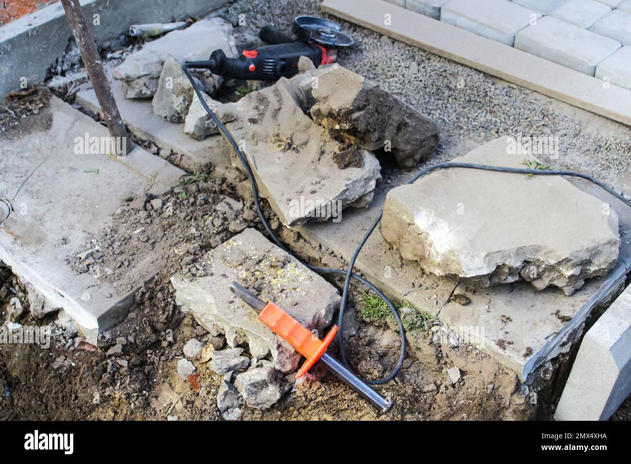 Defocus paving stones paving background. Installing tools on foreground ...