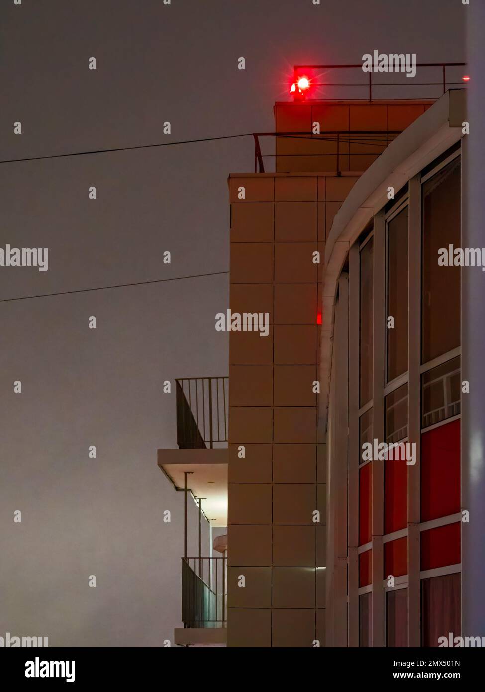 Red light signal on the top of highrise residential building Stock ...