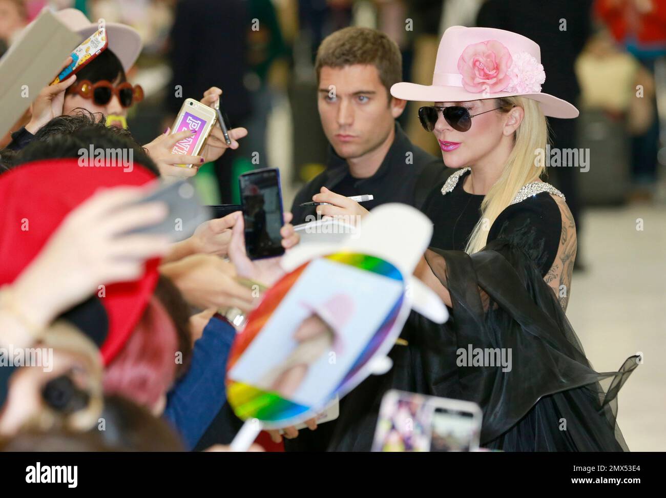 Lady Gaga gives her autographs to fans upon her arrival at Narita ...