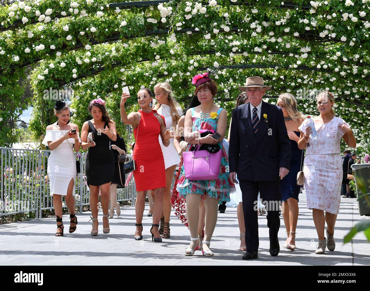 Racegoers arrive before the running of the Melbourne Cup horse racing ...