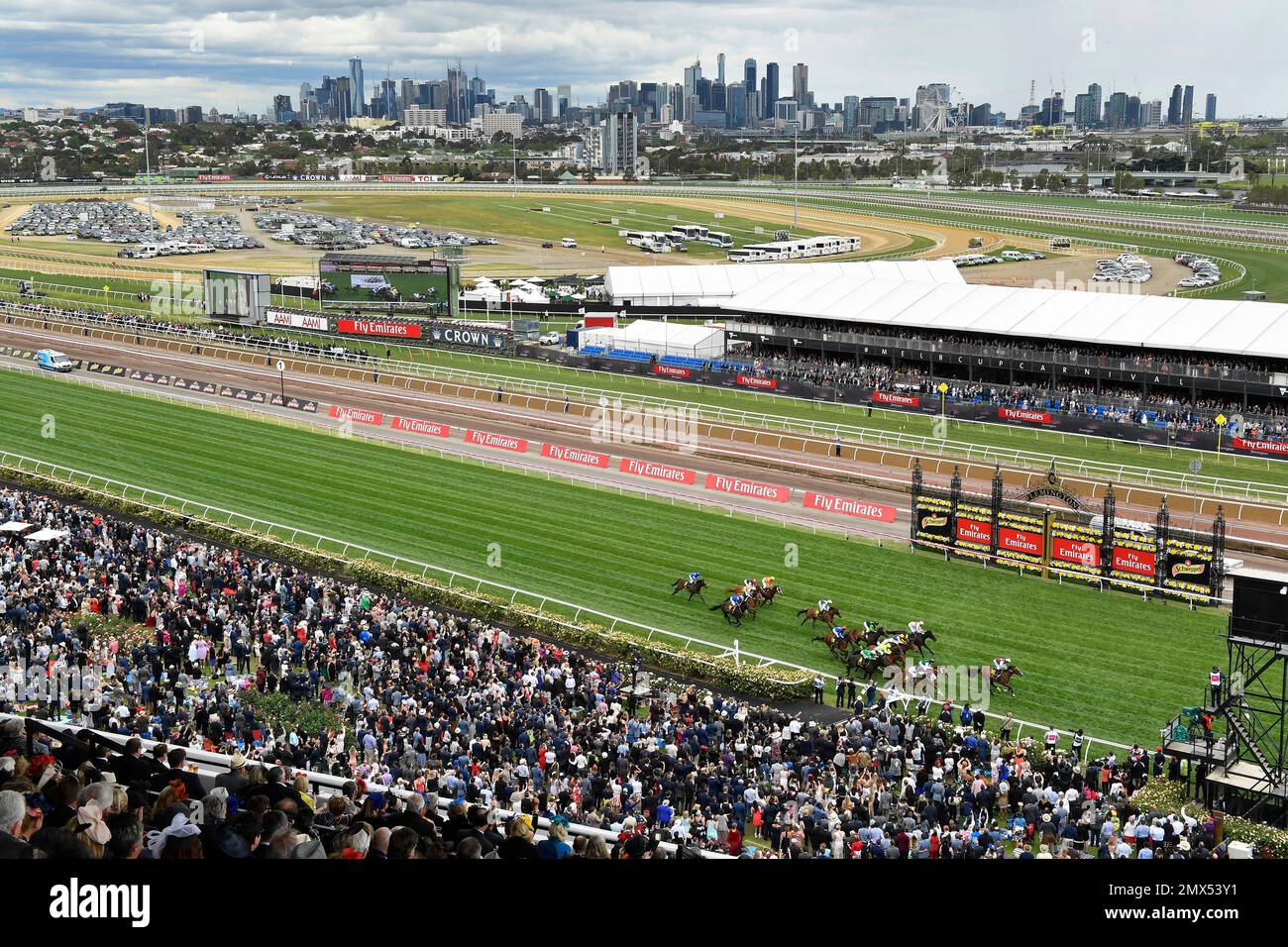 The city of Melbourne is seen as horses cross the finish line in race ...