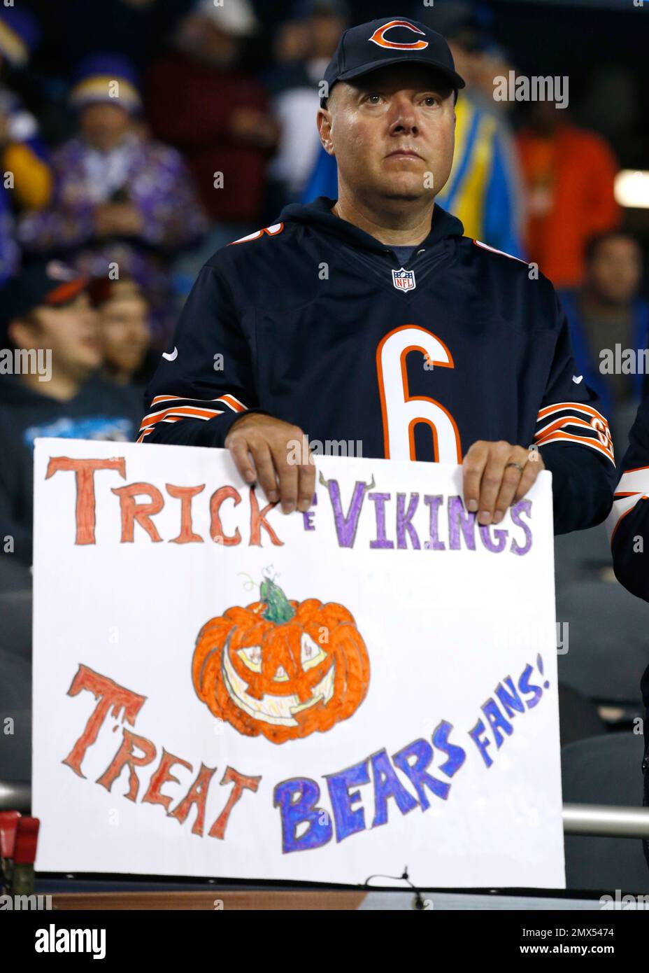 A Chicago Bears fan holds a sign during warmups before an NFL football ...