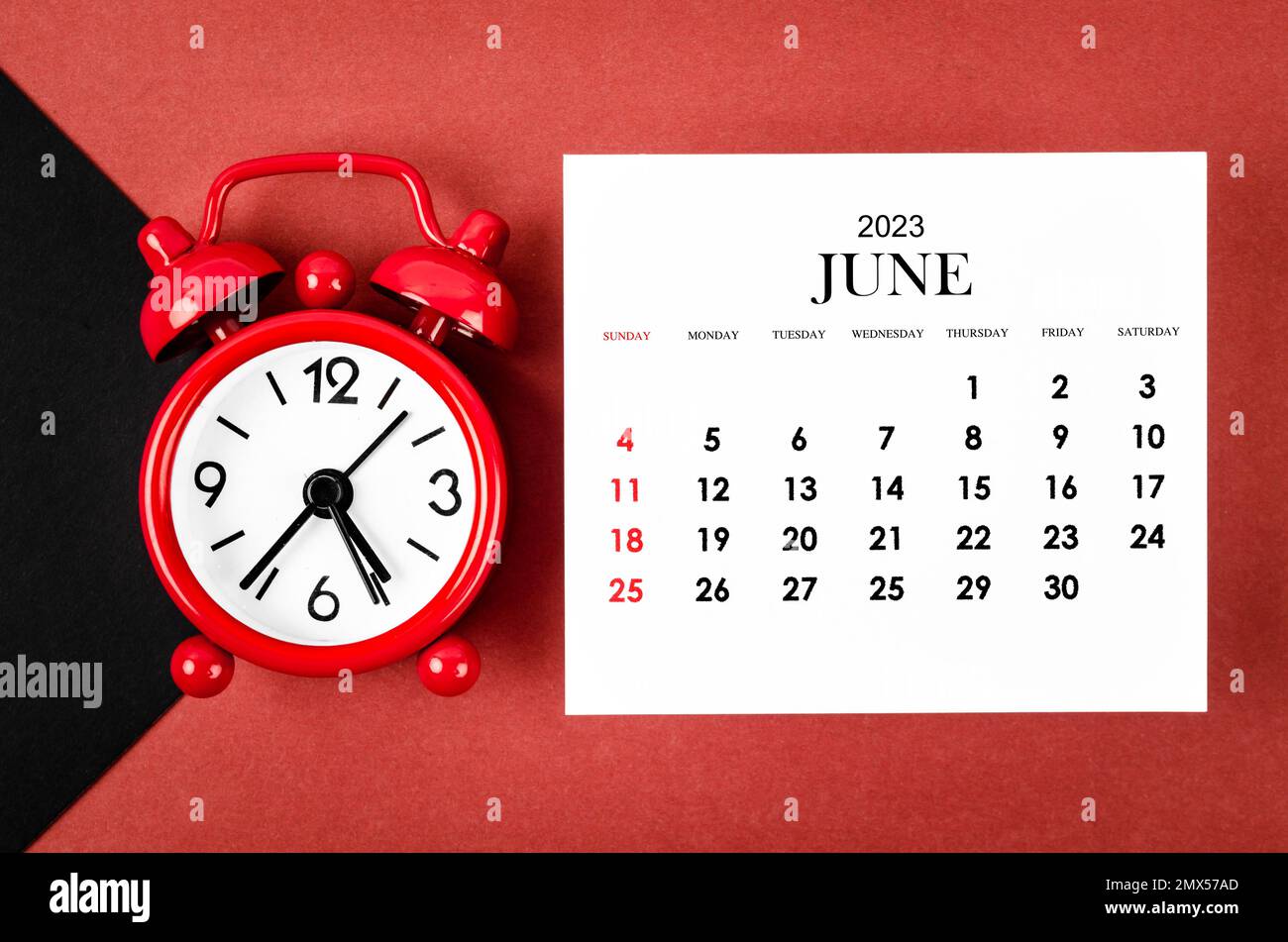 June 2023 Monthly calendar year with alarm clock on red and black background Stock Photo - Alamy