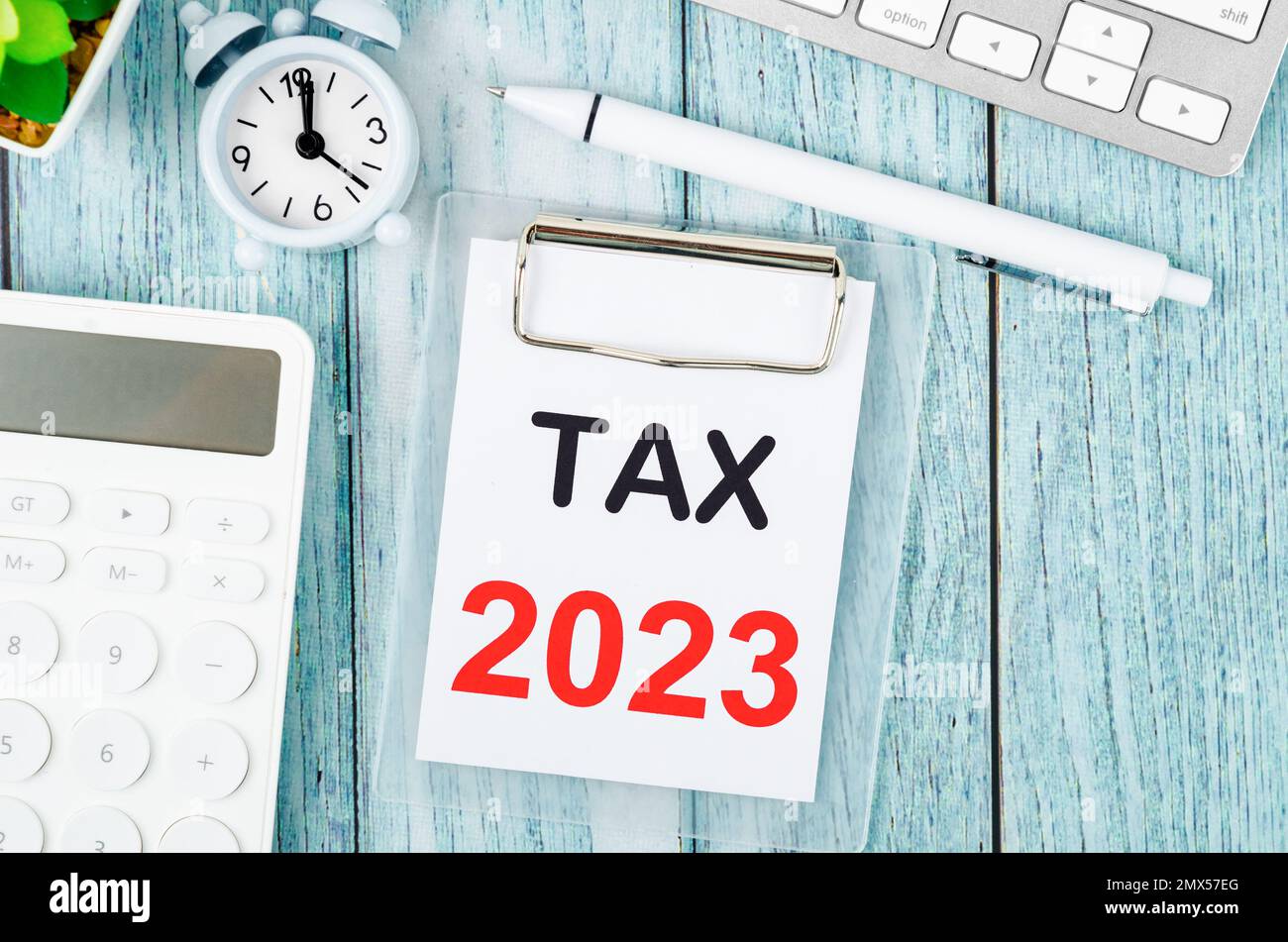 Tax 2023 text on clipboard with calculator on wooden background. 2023 ...