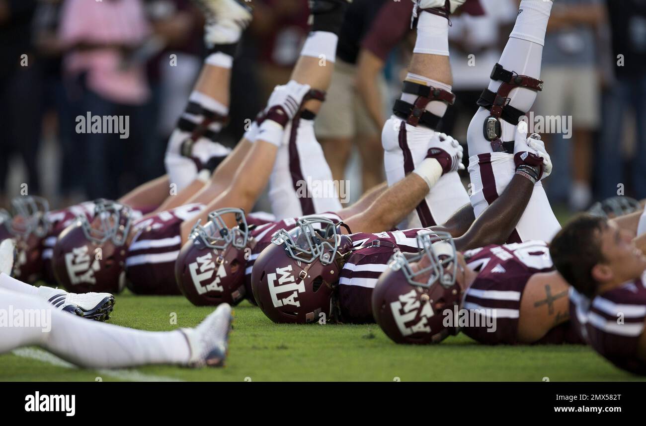 Members of the Texas A&M offensive line stretch before the start of an ...