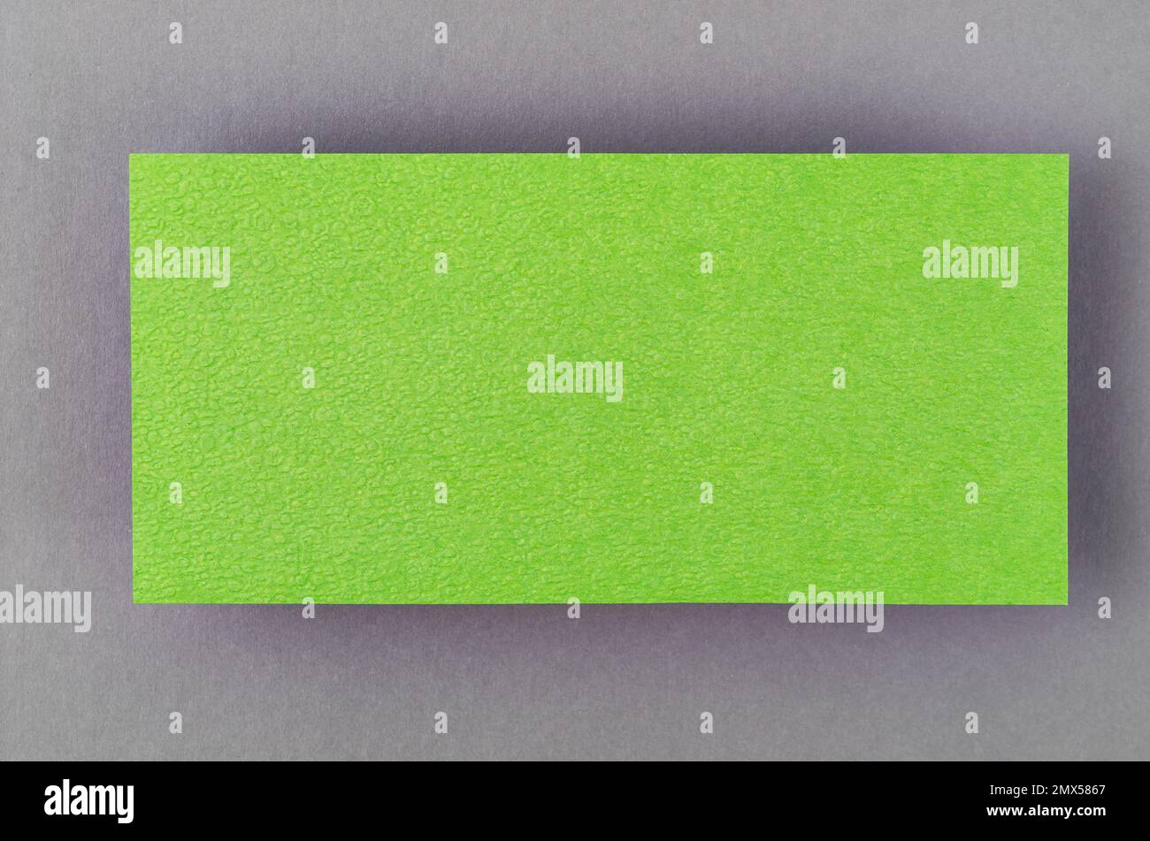 Blank green note paper on grey colour background Stock Photo - Alamy