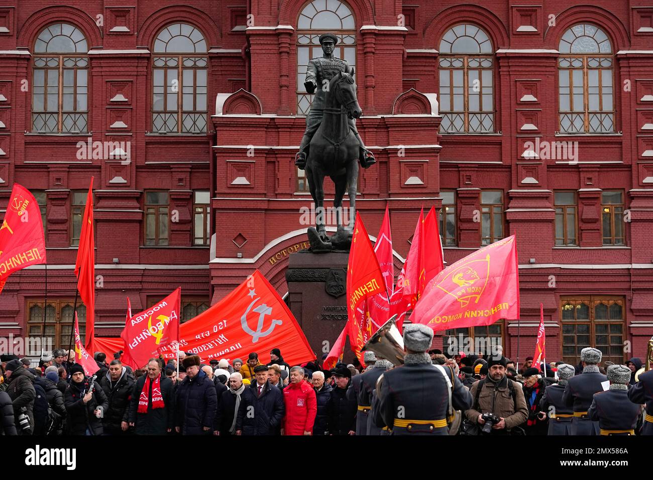 Communist's party supporters with Red flags gather around the statue of ...