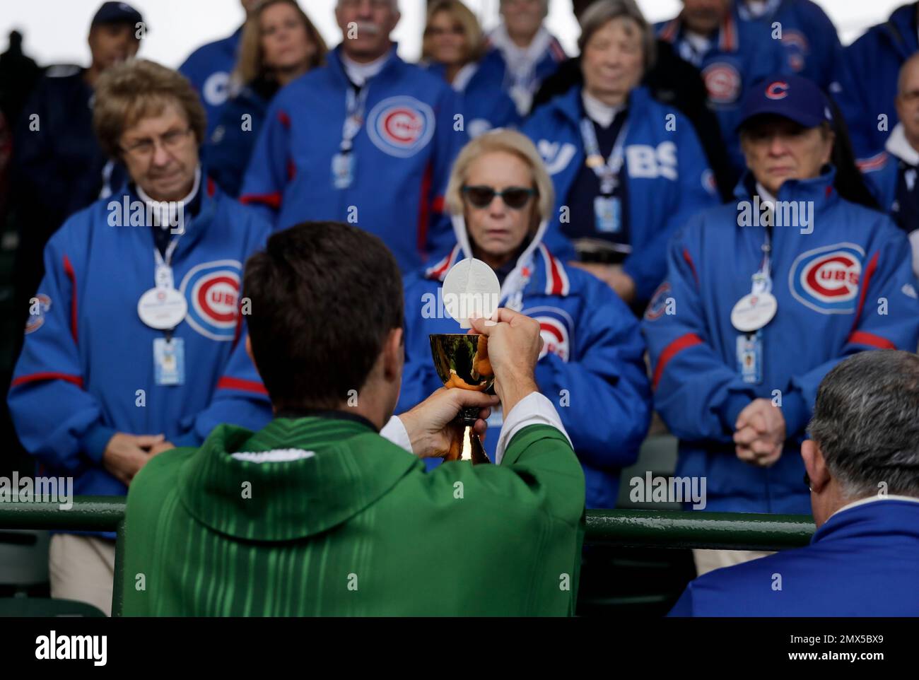 Rev. Burke Masters conducts a outdoor Mass in the Wrigley Field stands ...