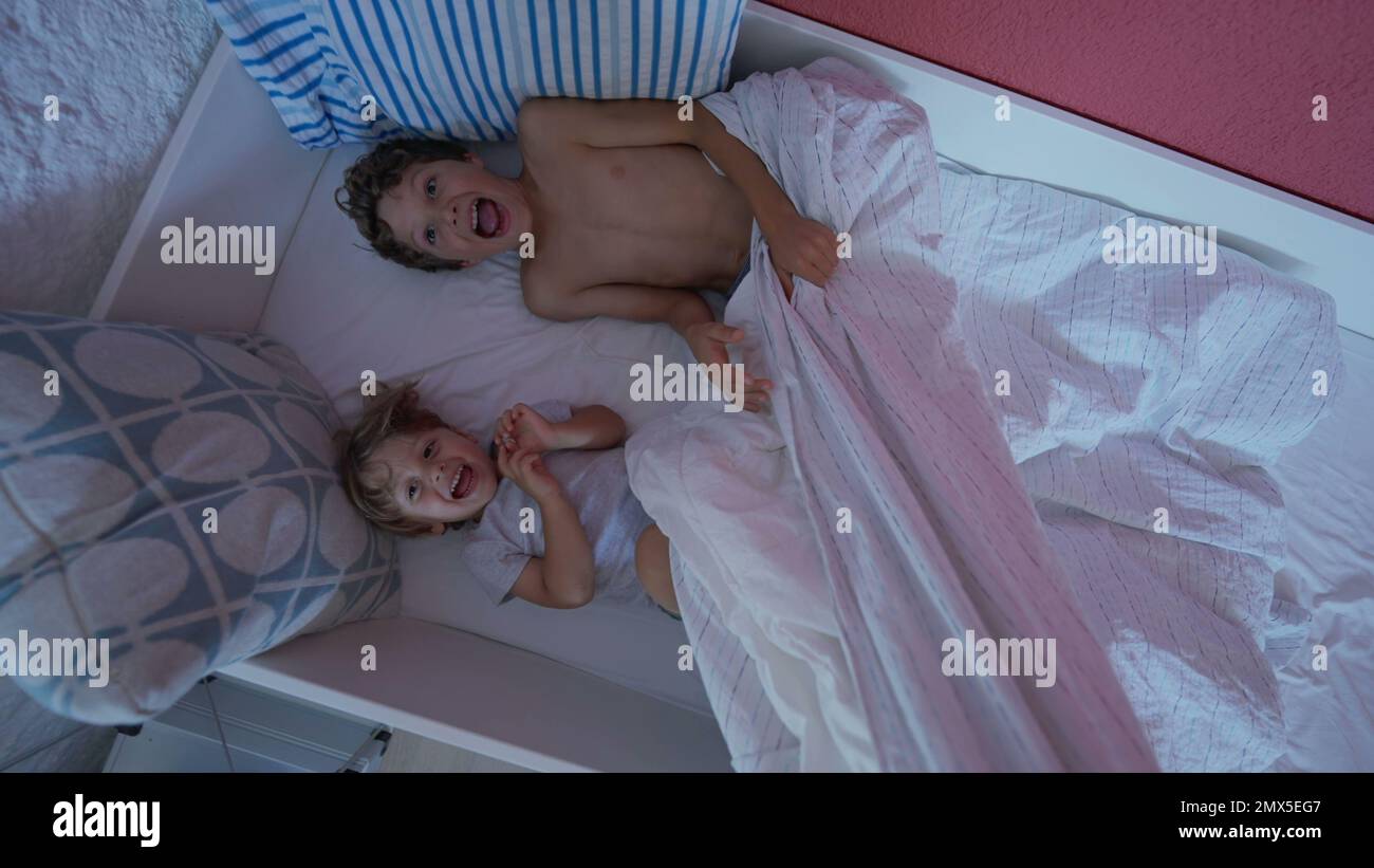 Happy children in morning bed. Cute little boy getting up from ...