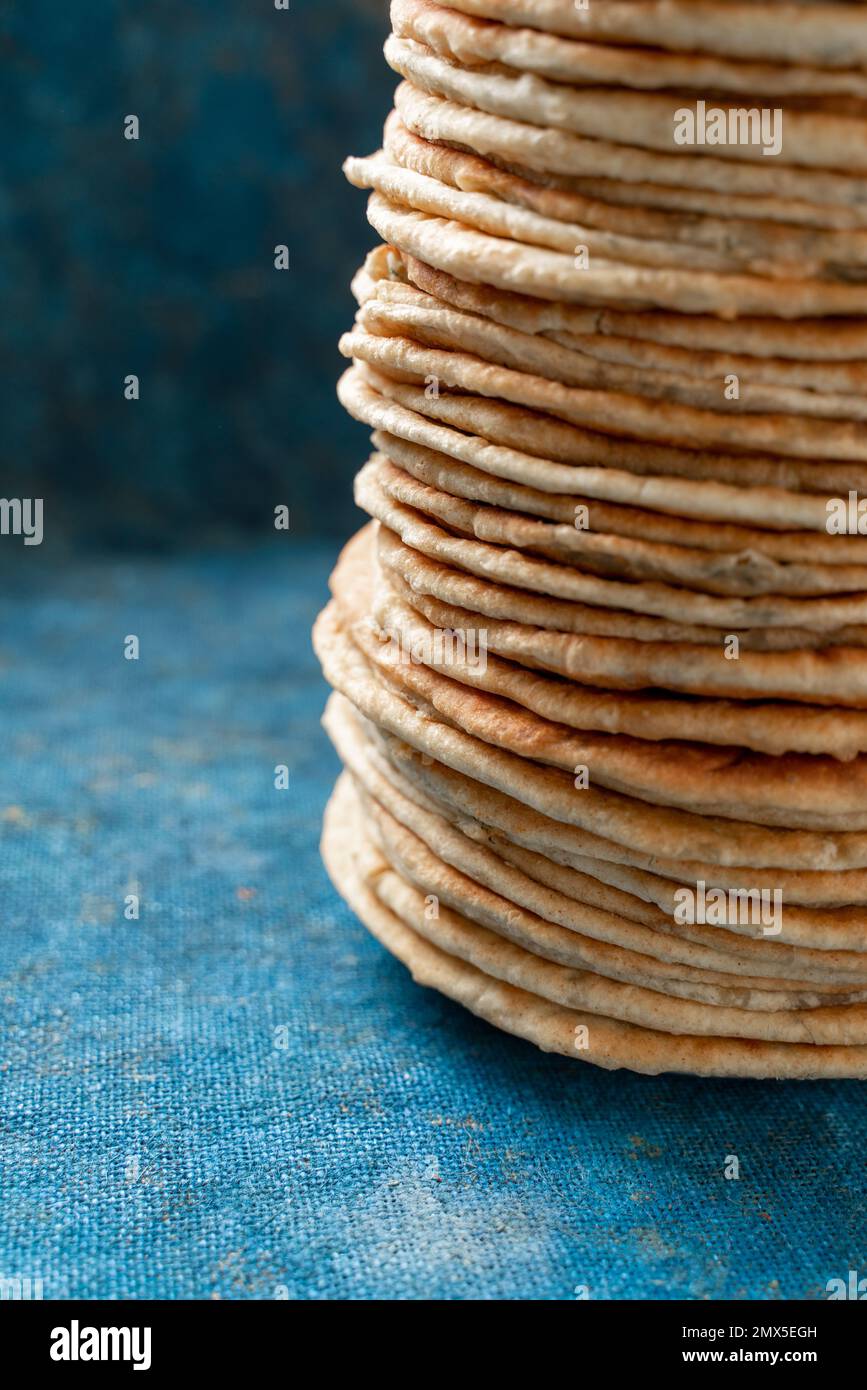 Flatbread lavash, chapati, naan, heap of tortilla on a blue background ...